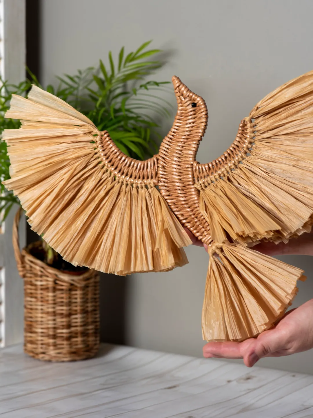 Hanging wicker bird with raffia. Boho wall decor. Handmade phoenix bird